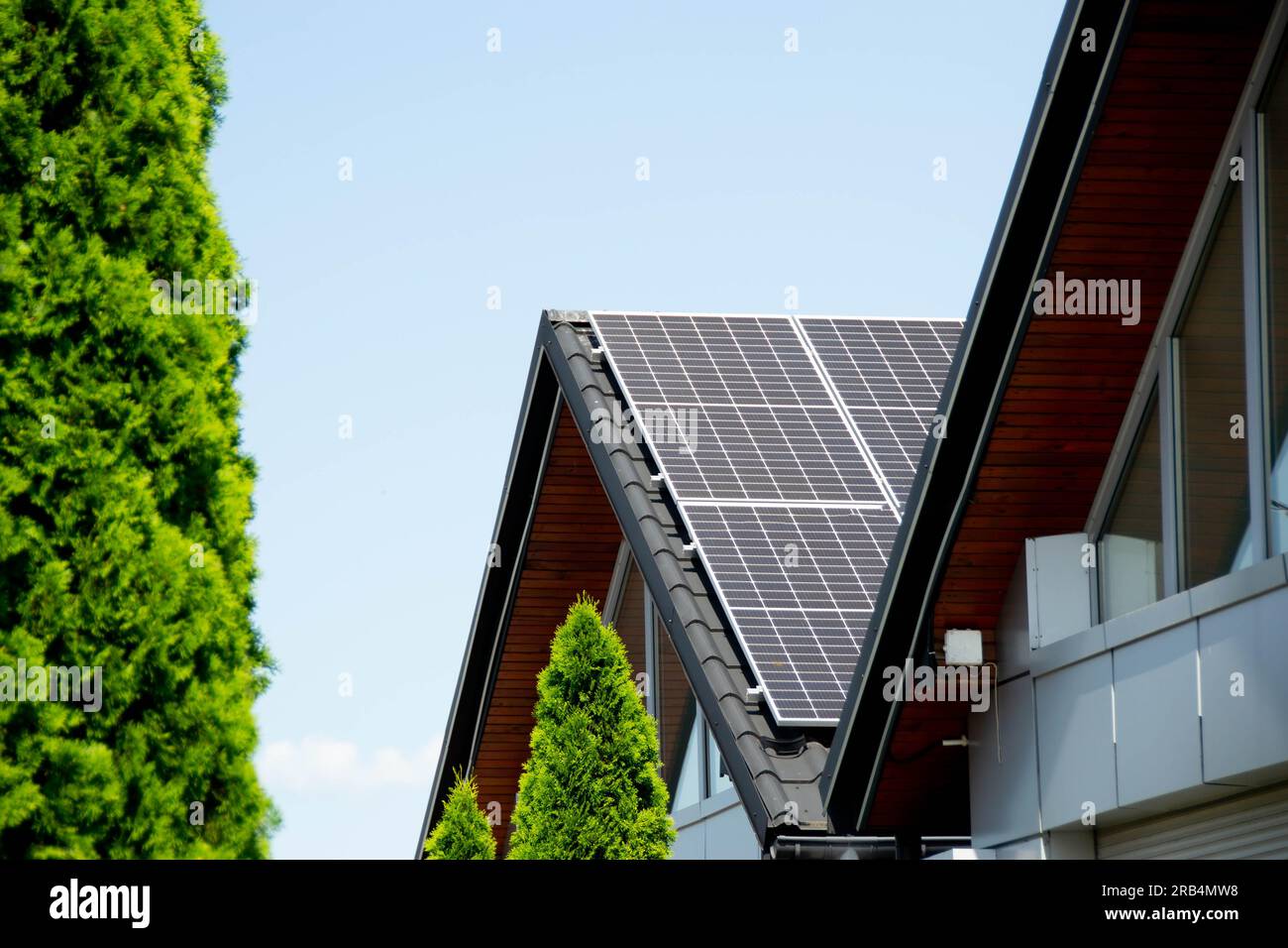 House roof with photovoltaic modules. Historic farm house with modern ...