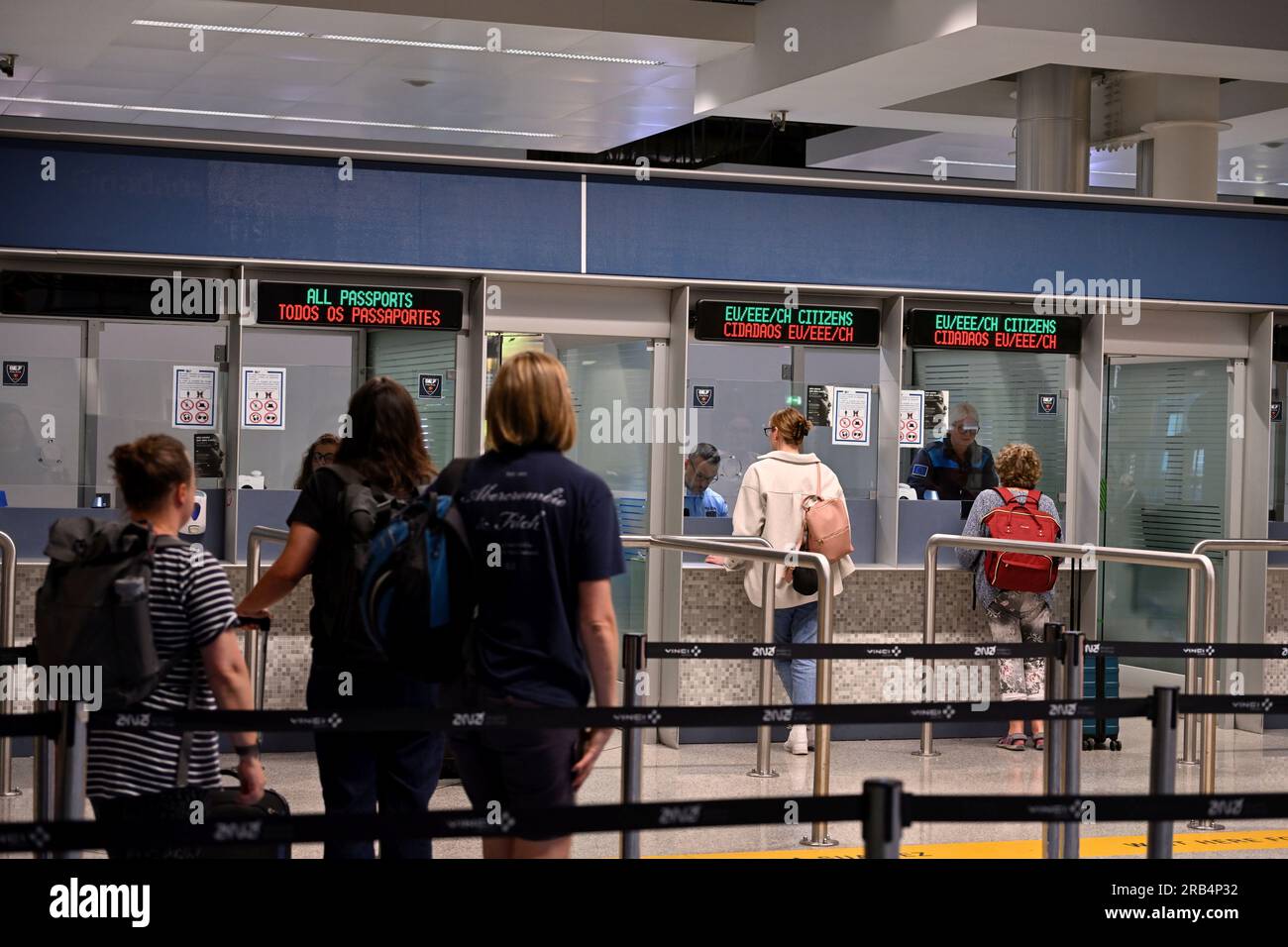 Travellers going through customs at arriving boarder check Stock Photo ...