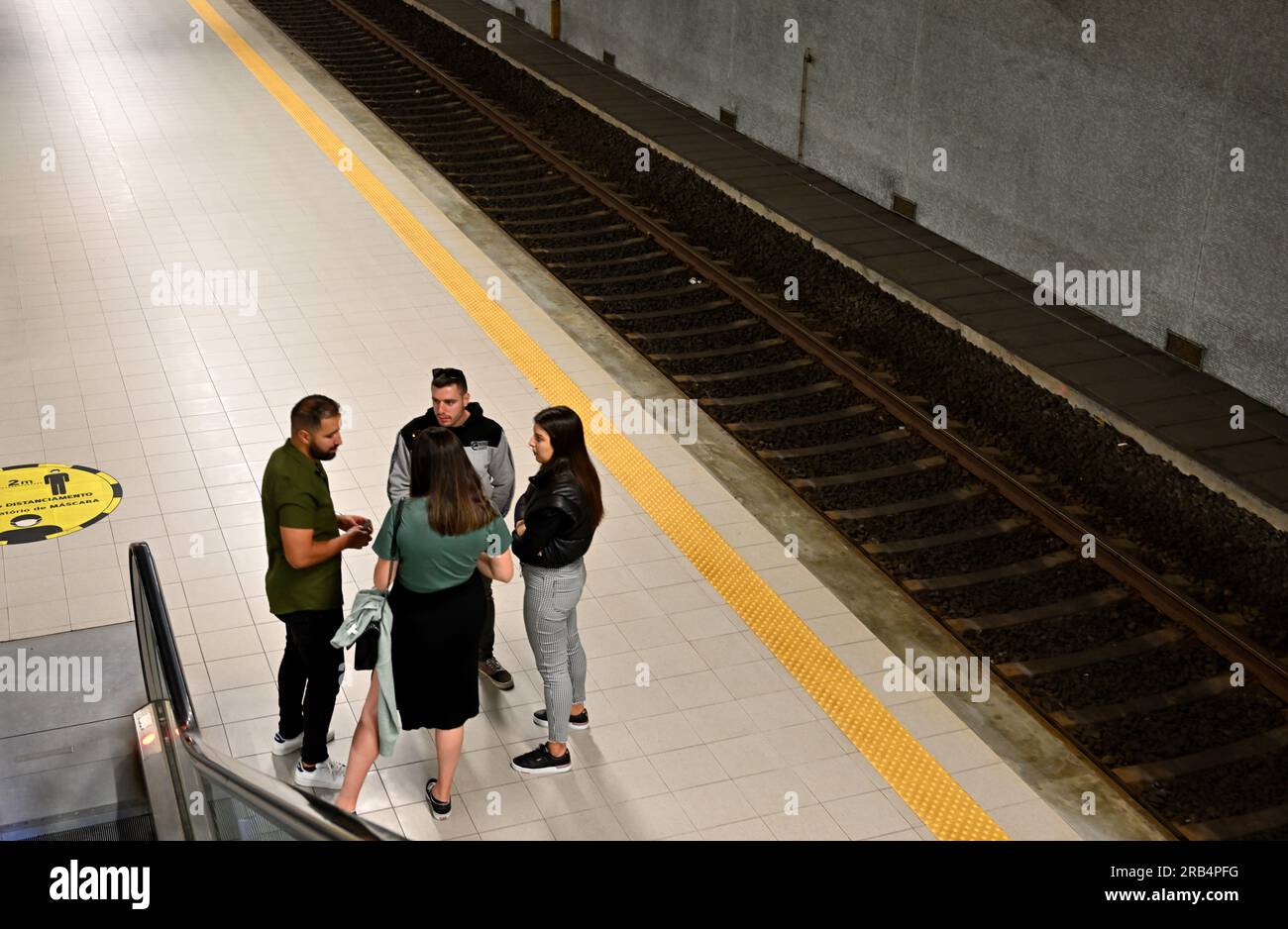People standing on train station platform waiting for train Stock Photo ...