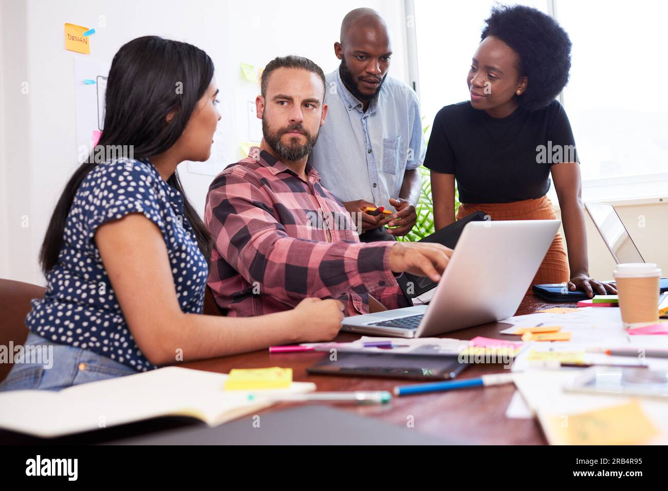 Serious team of developers brainstorming new app idea in boardroom ...
