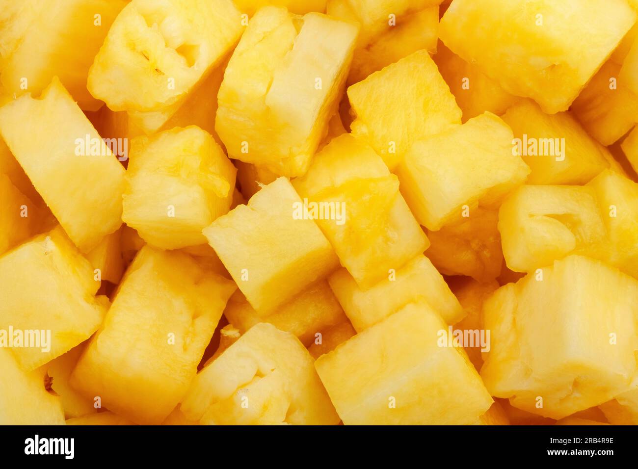 sliced pineapple cubes background pattern Stock Photo - Alamy