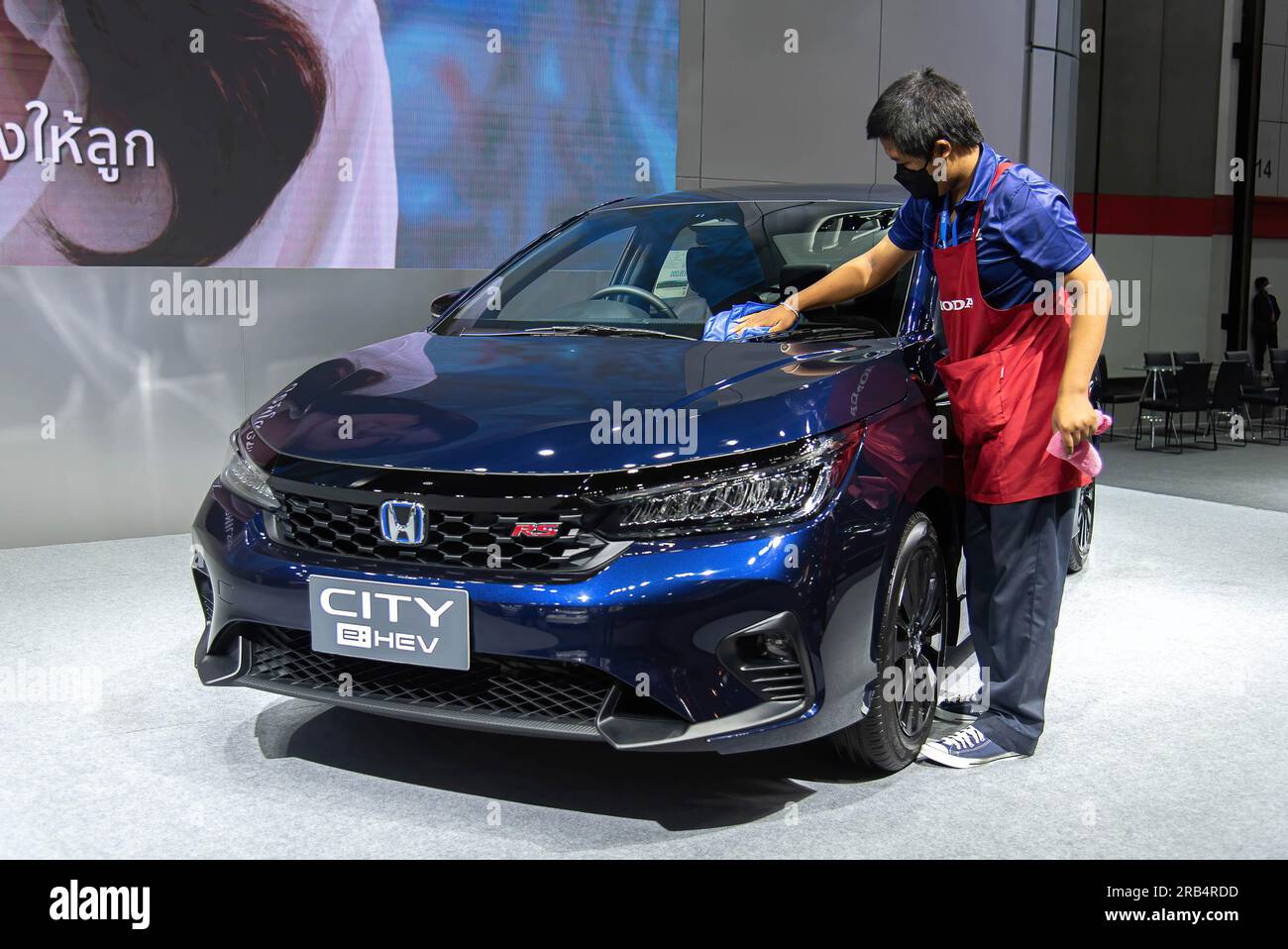 A worker seen cleaning a Honda City e:HEV car during Thailand Fast Auto ...