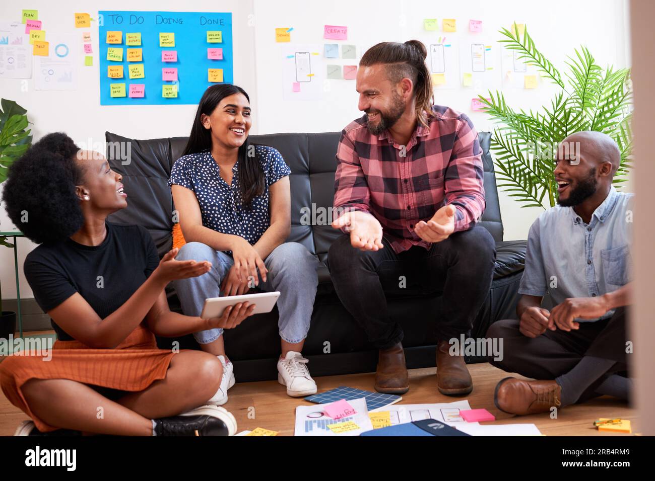 Group of diverse colleagues brainstorm together, informal meeting sit ...