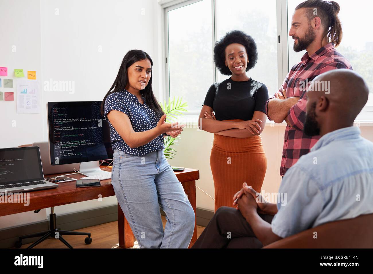 Diverse group of colleagues standing and chatting in the office, coding company Stock Photo - Alamy