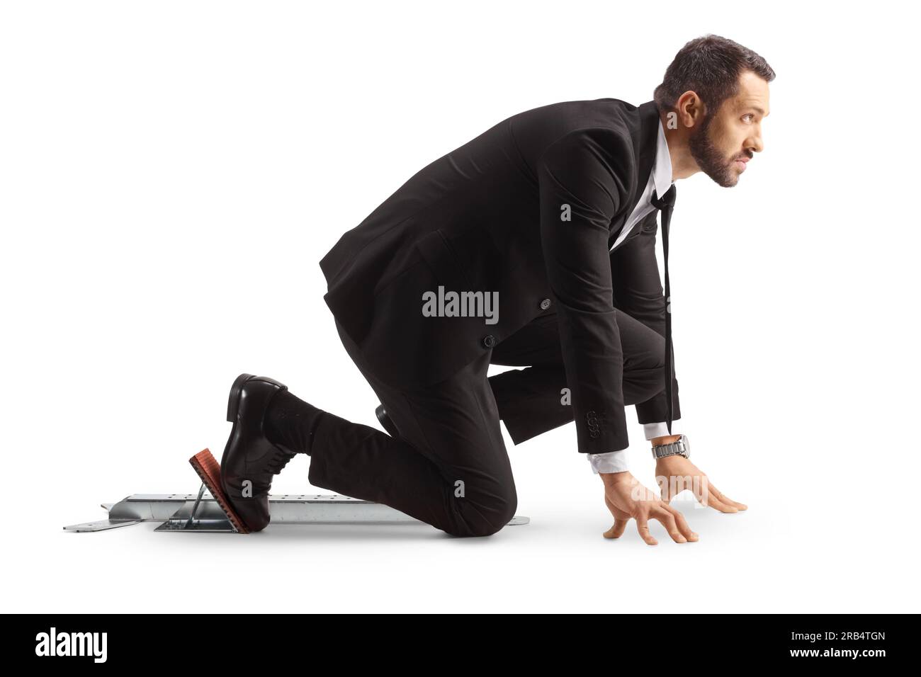 Full length profile shot of a businessman preparing for a run on ...