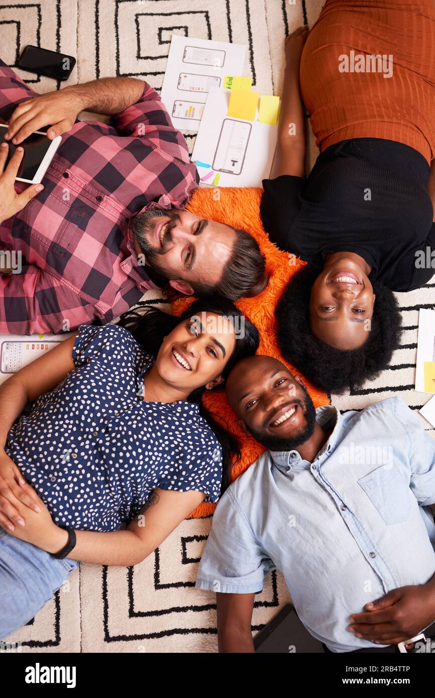 Overhead shot of multiracial group of coworkers, taking a break tech ...