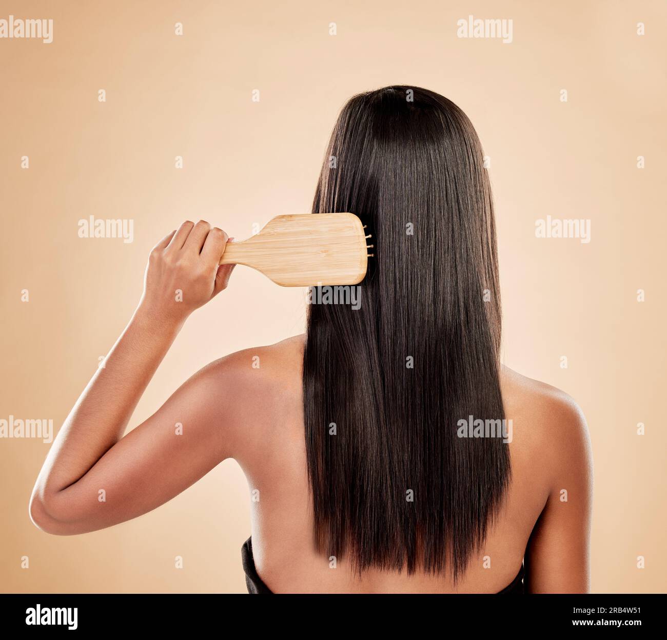 Back of woman, brush and hair care in studio, background and grooming ...