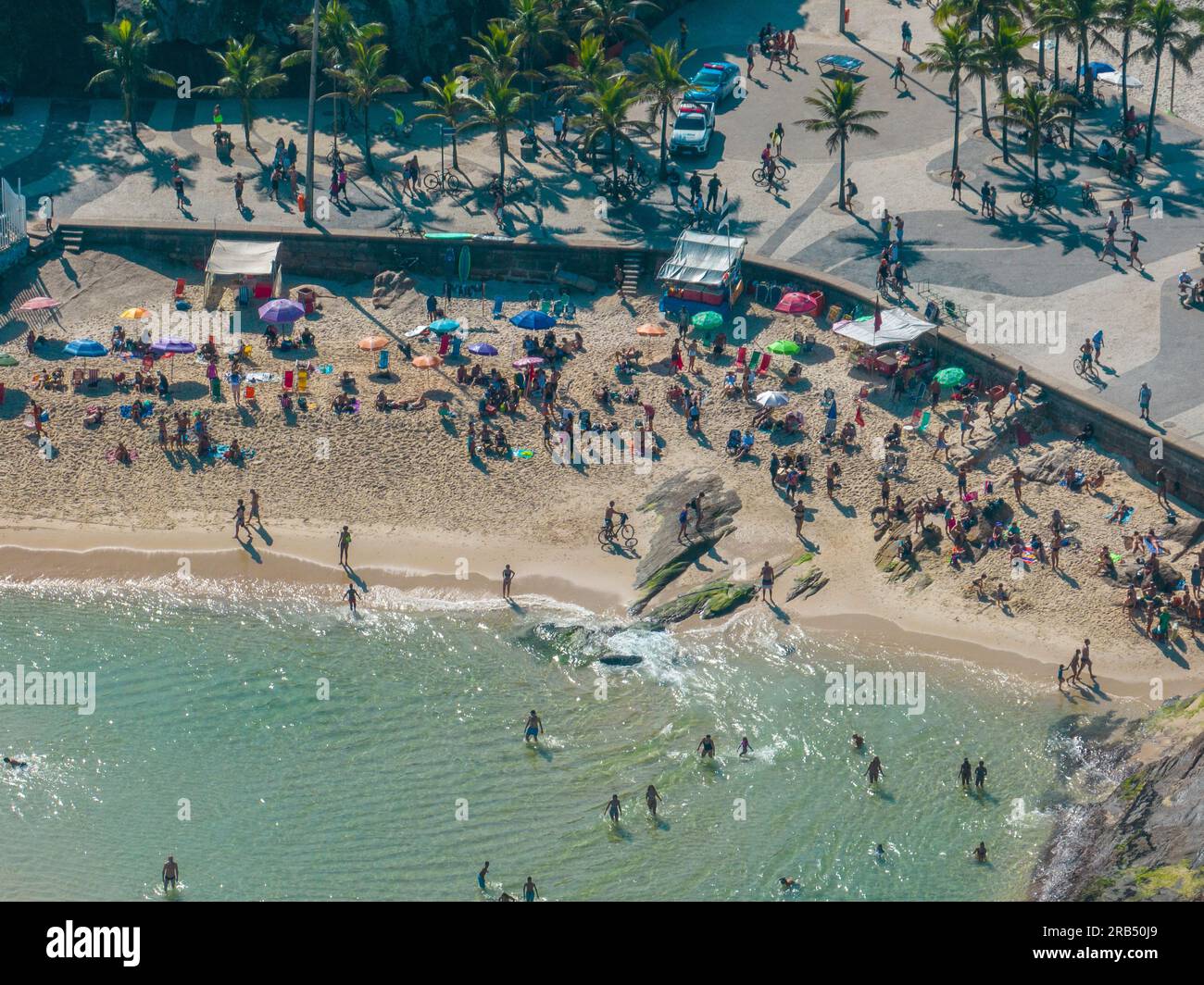 Aerial view of Ipanema beach. People sunbathing and playing on the beach, sea sports. Surfing ...