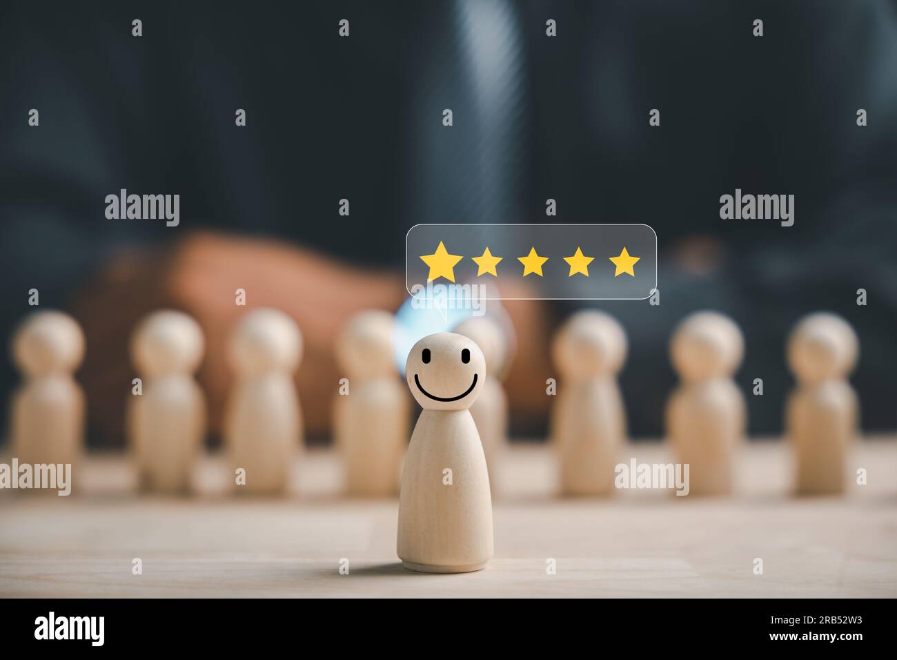 Hand choosing a wooden figure as the chosen leader from the crowd Stock ...