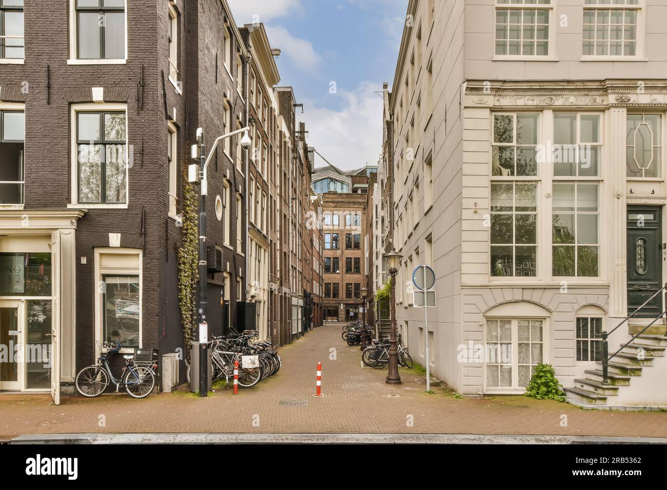 a city street with bikes parked on the side walk way in front of ...