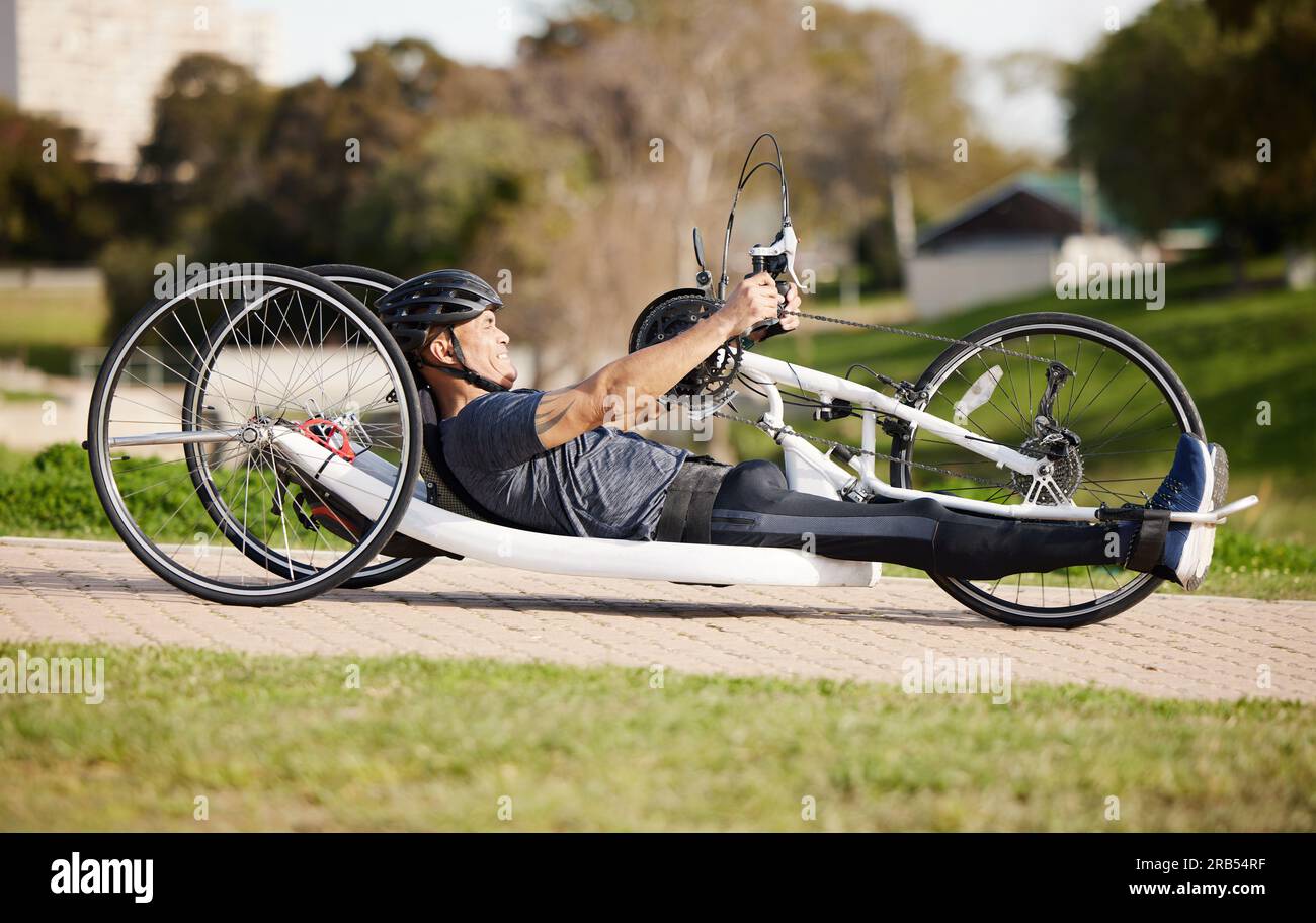 Cycling, fitness and cardio with man and handcycle in nature for ...