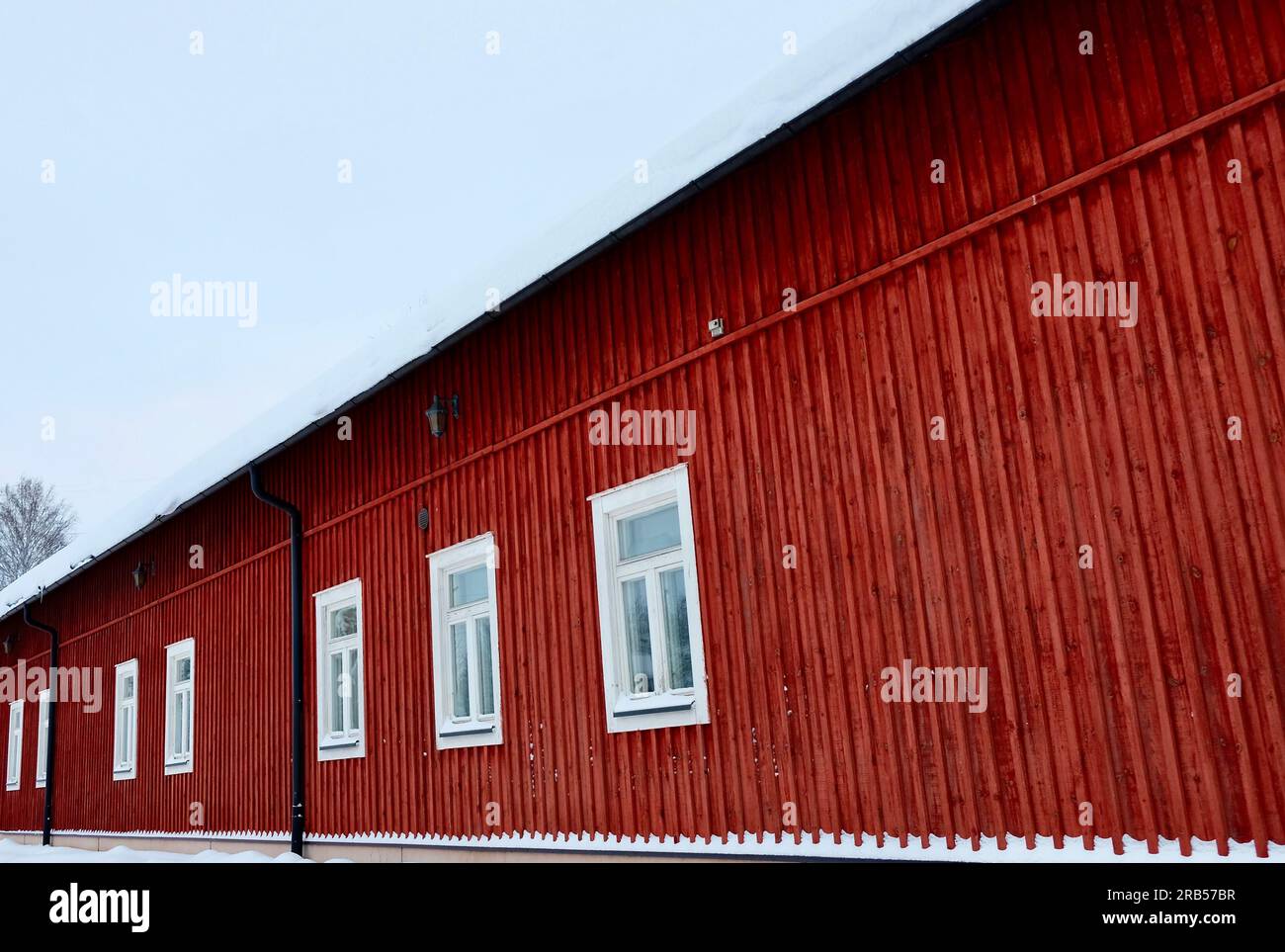 Side perspective view to the old red painted wooden building wall with ...