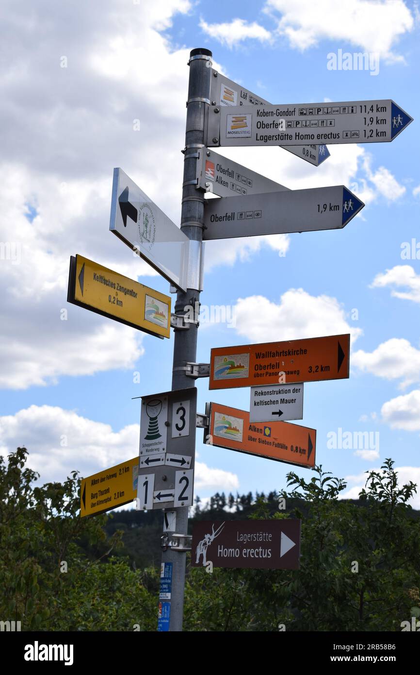 hiking trail sign with too many signs Stock Photo - Alamy