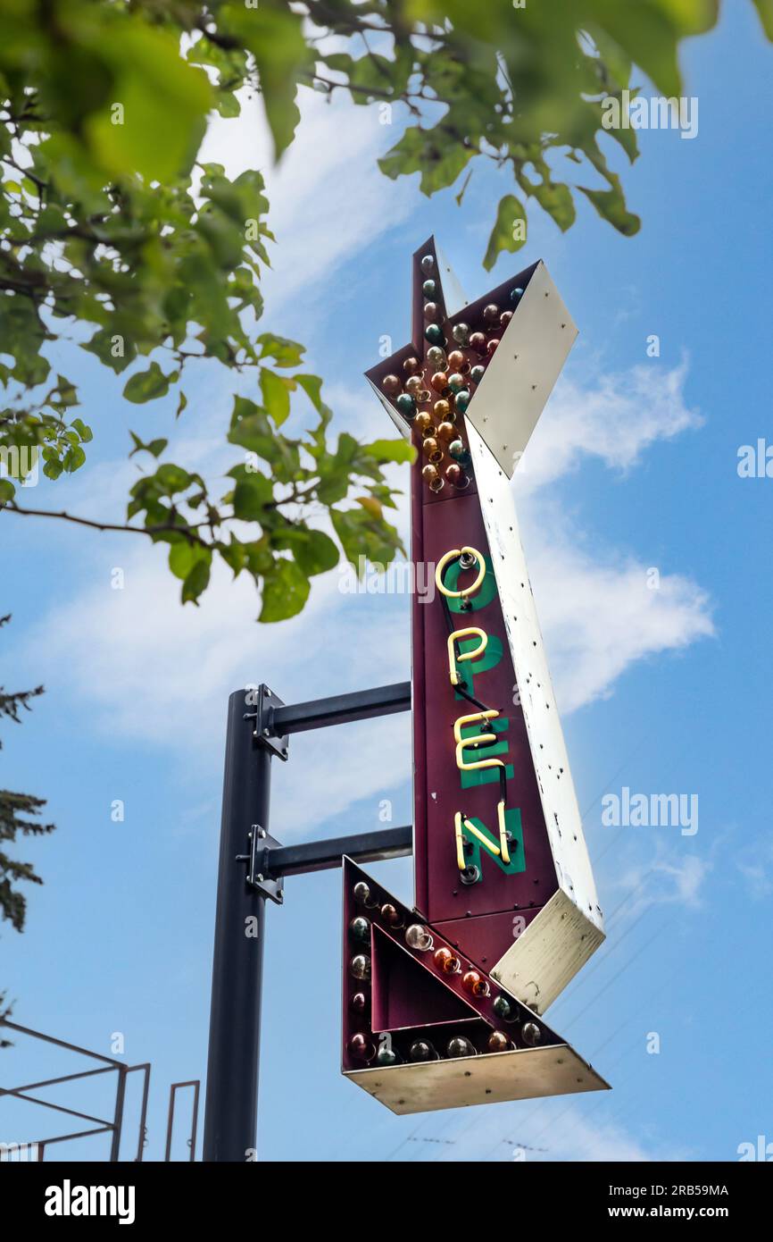 Vintage Arrow sign with Neon Open that lights up Stock Photo - Alamy