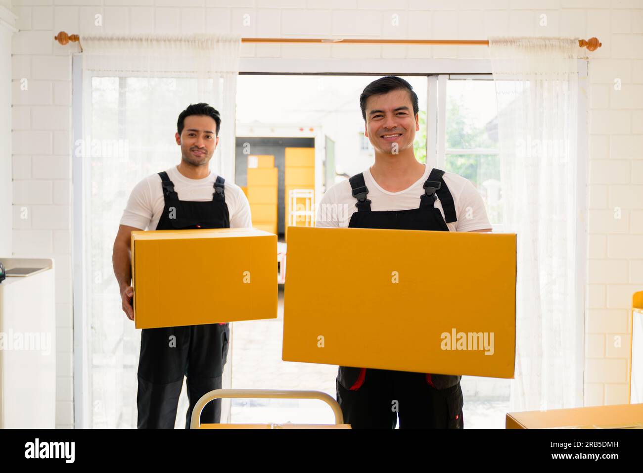 Happy two delivery men holding parcel boxes to customer, Delivery men ...