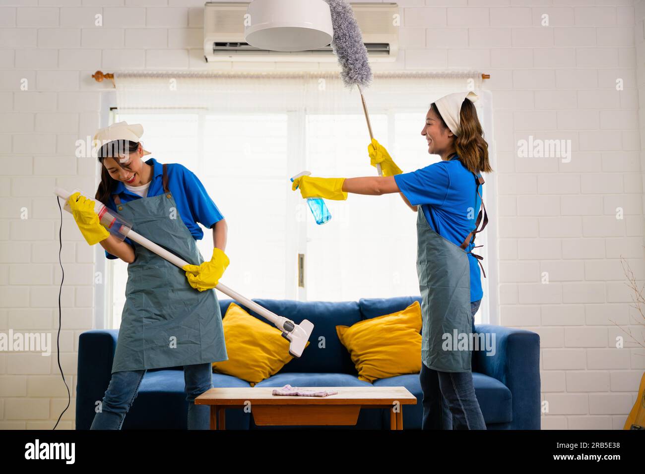 Couple of housekeeping staff cleaning house, Housekeeping and cleaning ...