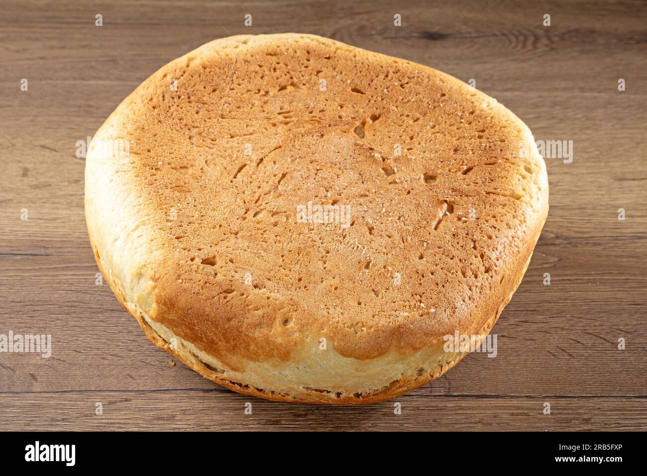 Homemade Ukrainian bread made from white wheat flour on a wooden table ...