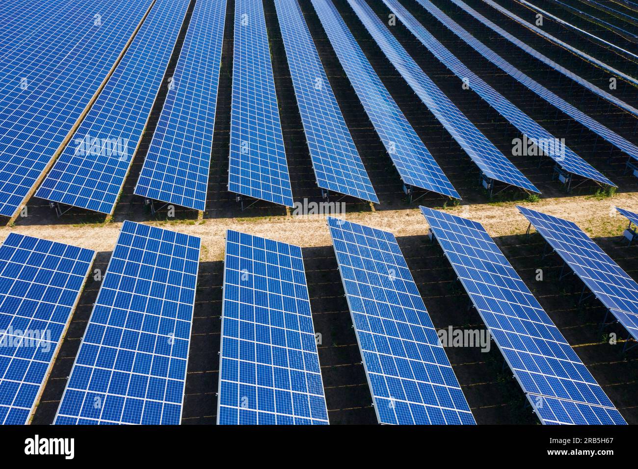 Aerial view over solar panels of photovoltaic power station / solar ...