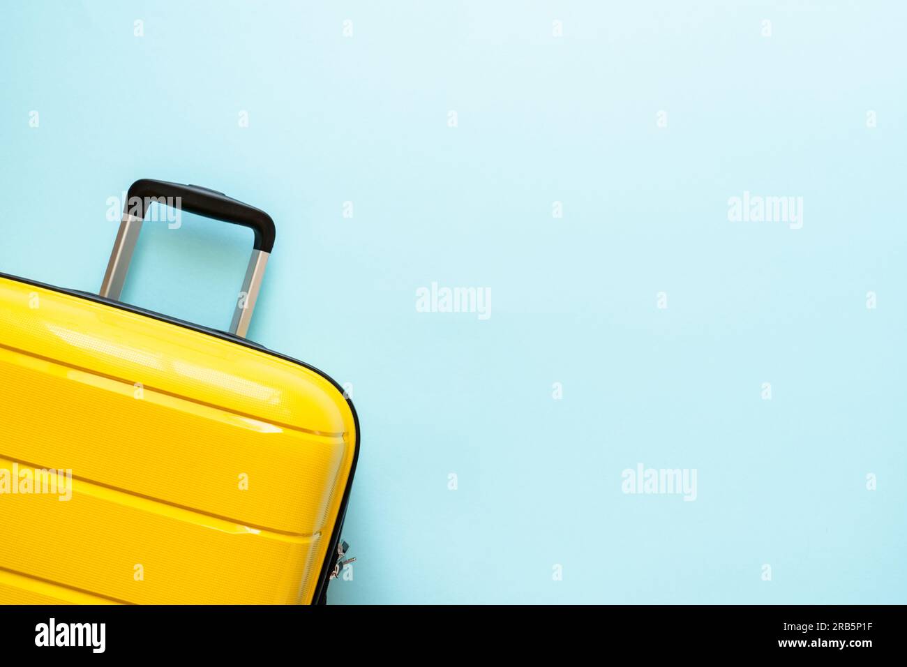 Suitcase on blue background top view Stock Photo - Alamy
