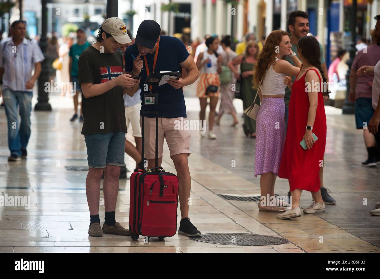 A tourist is seen chatting with a worker in central city. Spain has ...