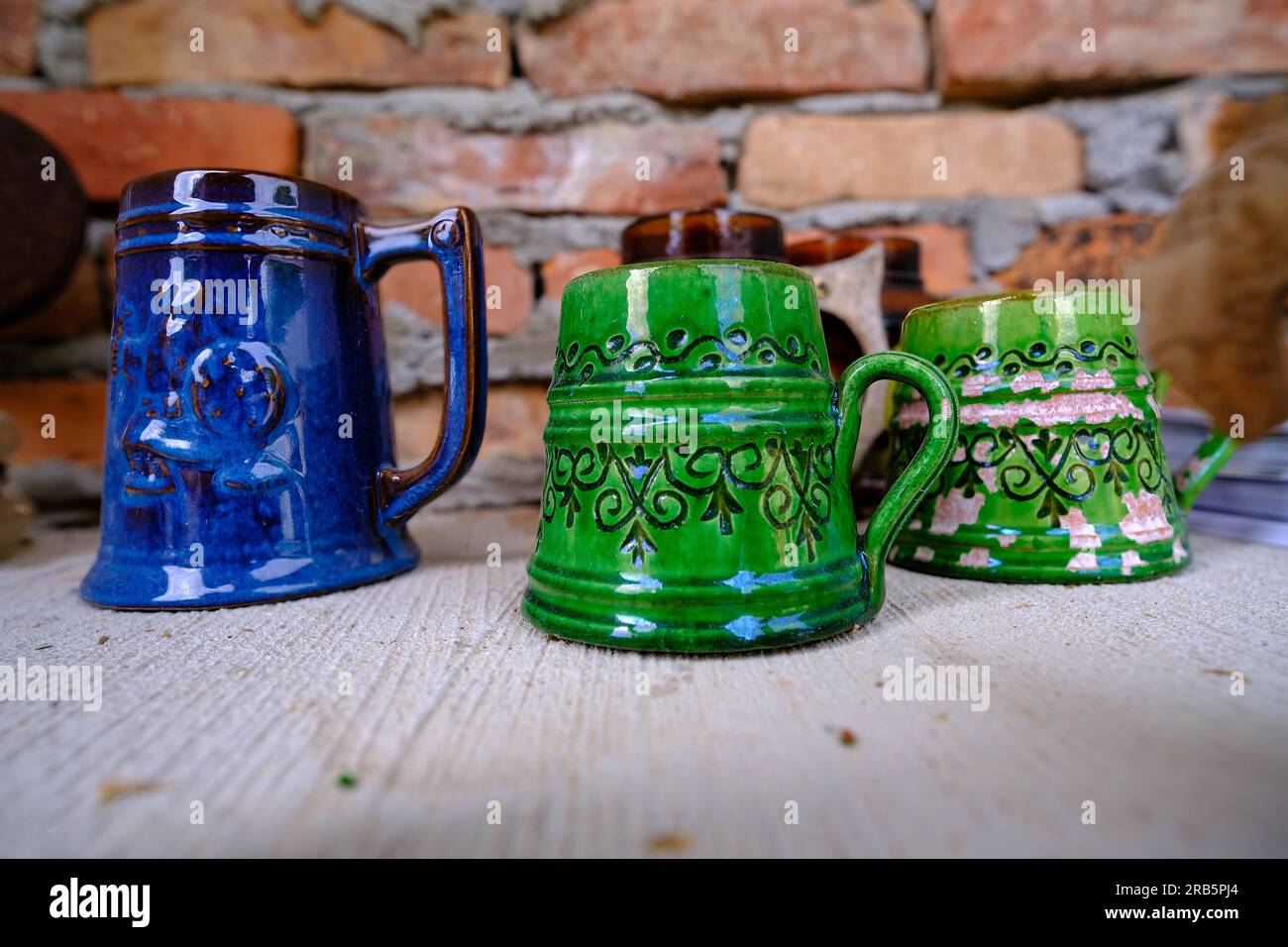 Traditional Latvian old clay cups. Cups of different sizes and colors ...