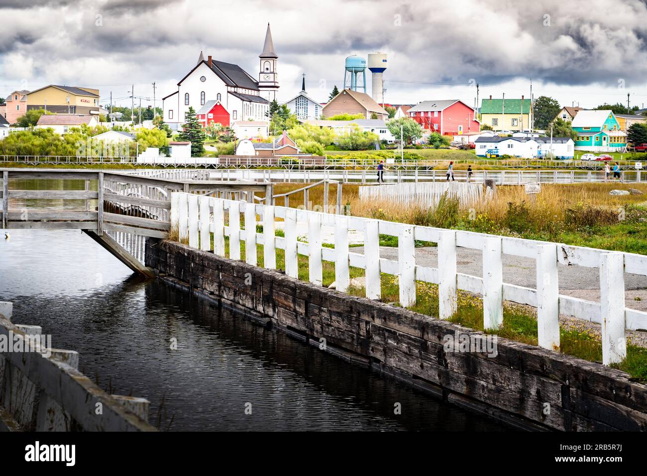 Wooden boardwalk along Old Bay Pond with a historic church landmarks ...