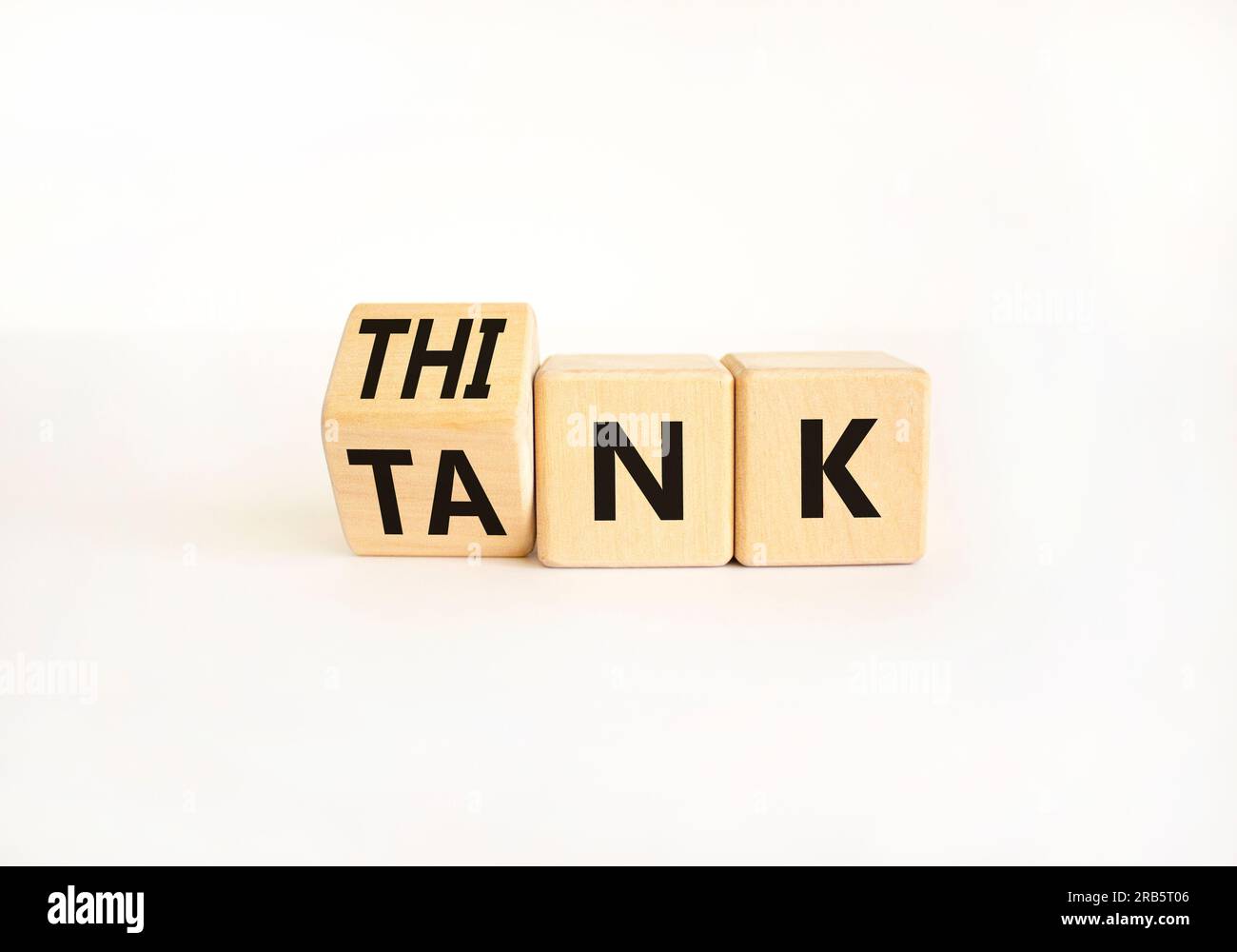 Think tank symbol. Businessman turns wooden cubes and changes the word ...