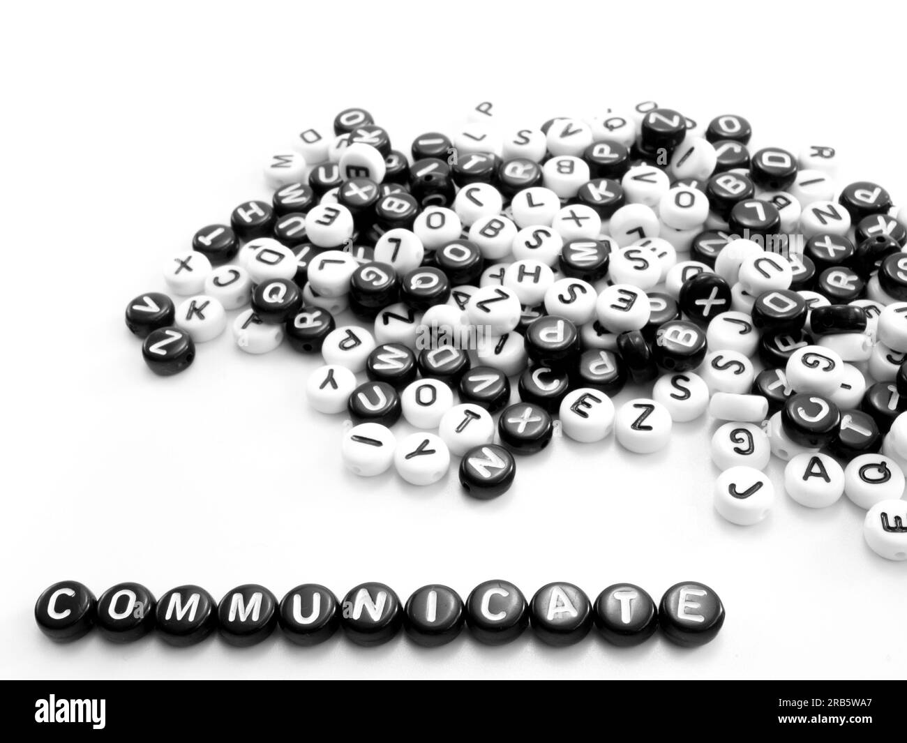 Heap of round letters black and white and communicate word written by ...