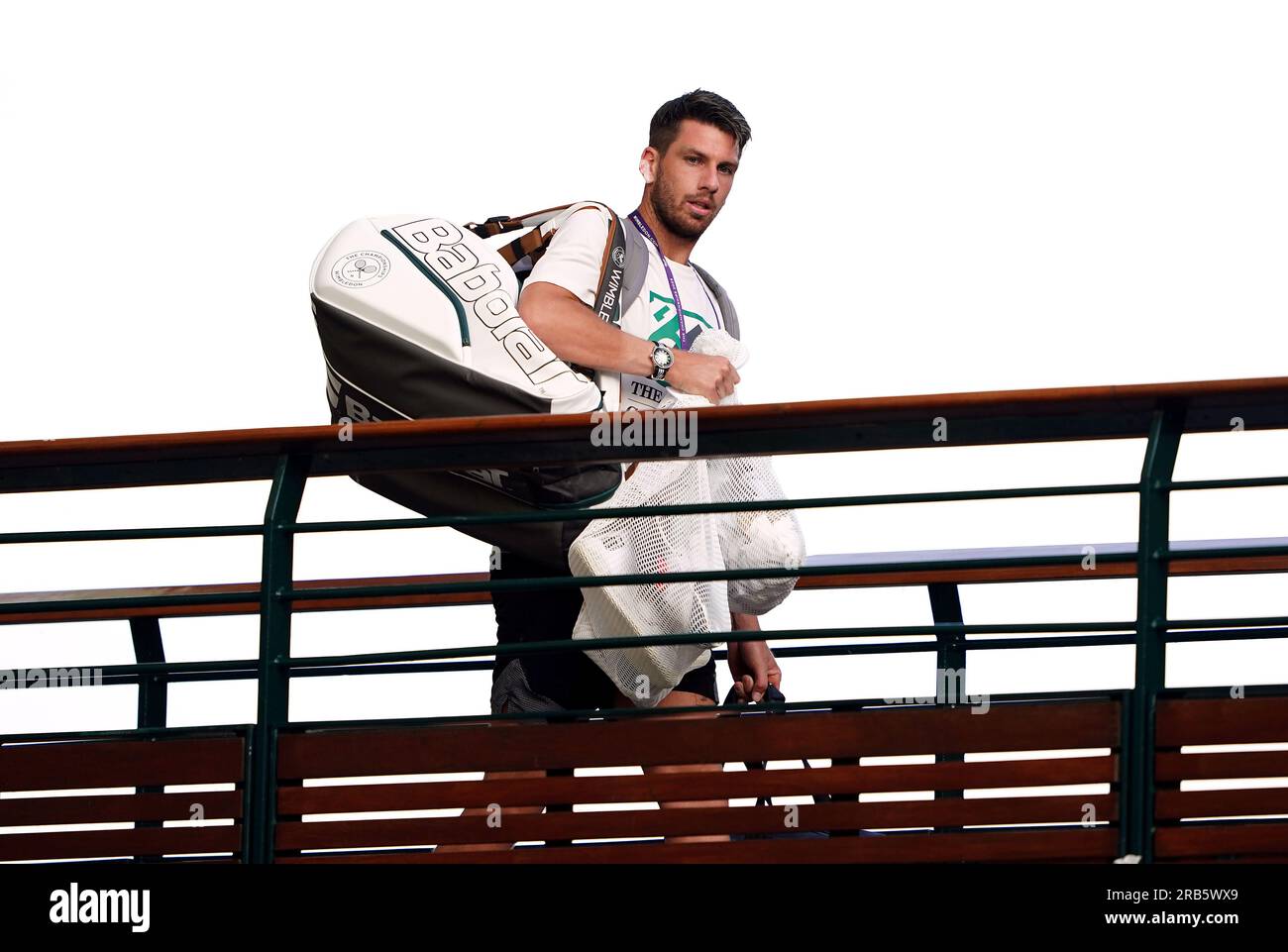 Cameron Norrie walks across a bridge within the grounds on day five of ...