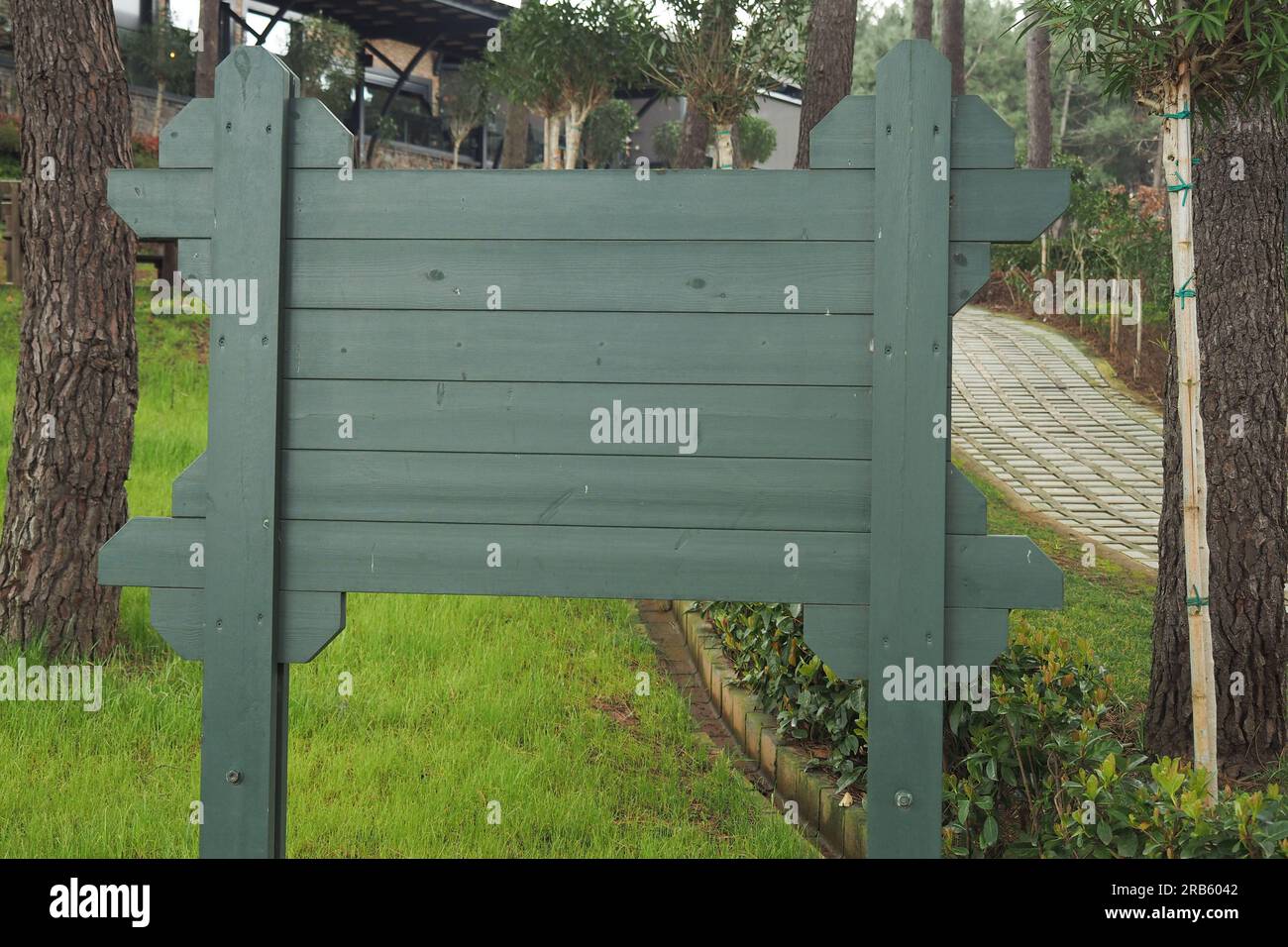 green wooden sign in the a park with copy space concept Stock Photo - Alamy