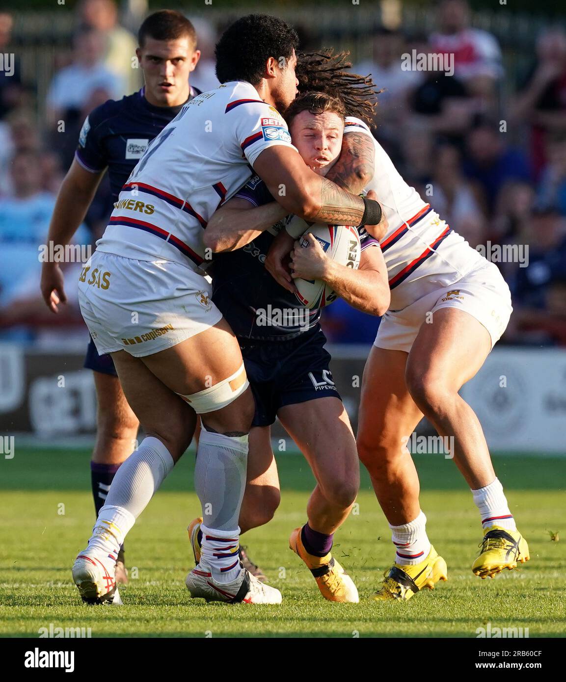 Wigan Warriors' Jai Field tackled by Wakefield Trinity's Renouf Atoni ...