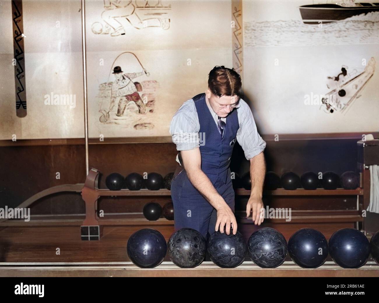 Man choosing bowling ball at bowling alley, Clinton, Indiana, USA ...