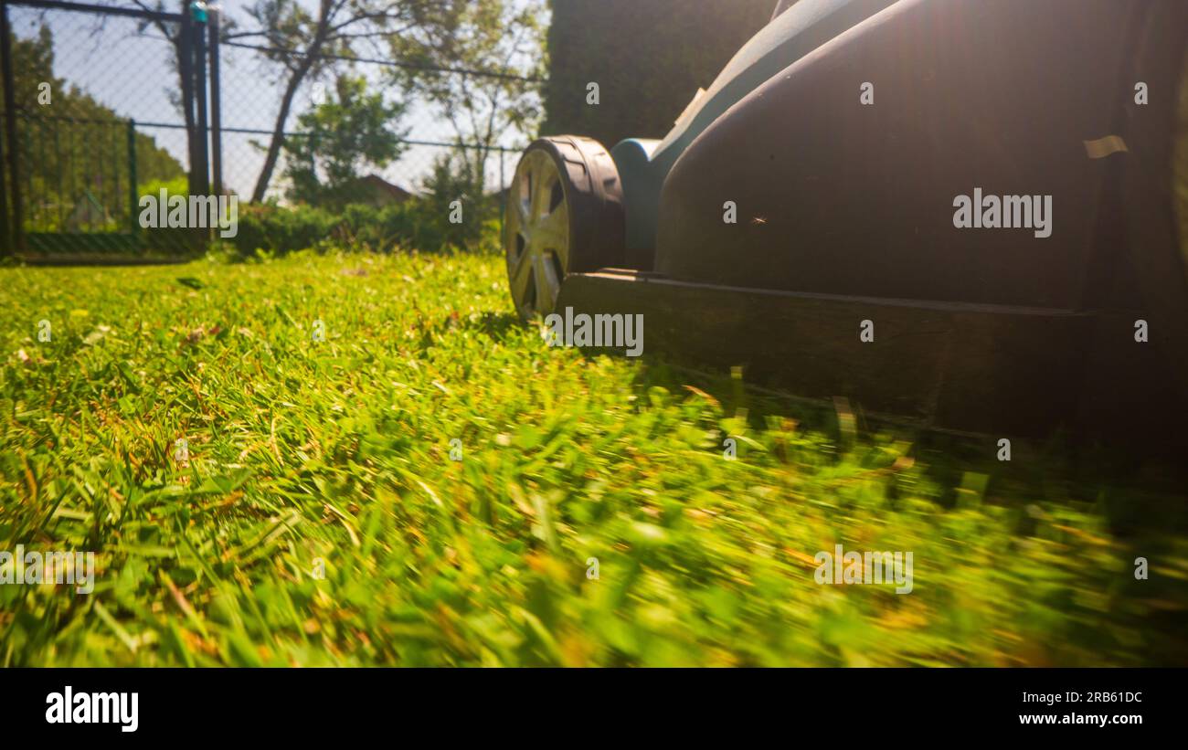 Lawn mover on green grass in modern garden or backyard. Machine for ...