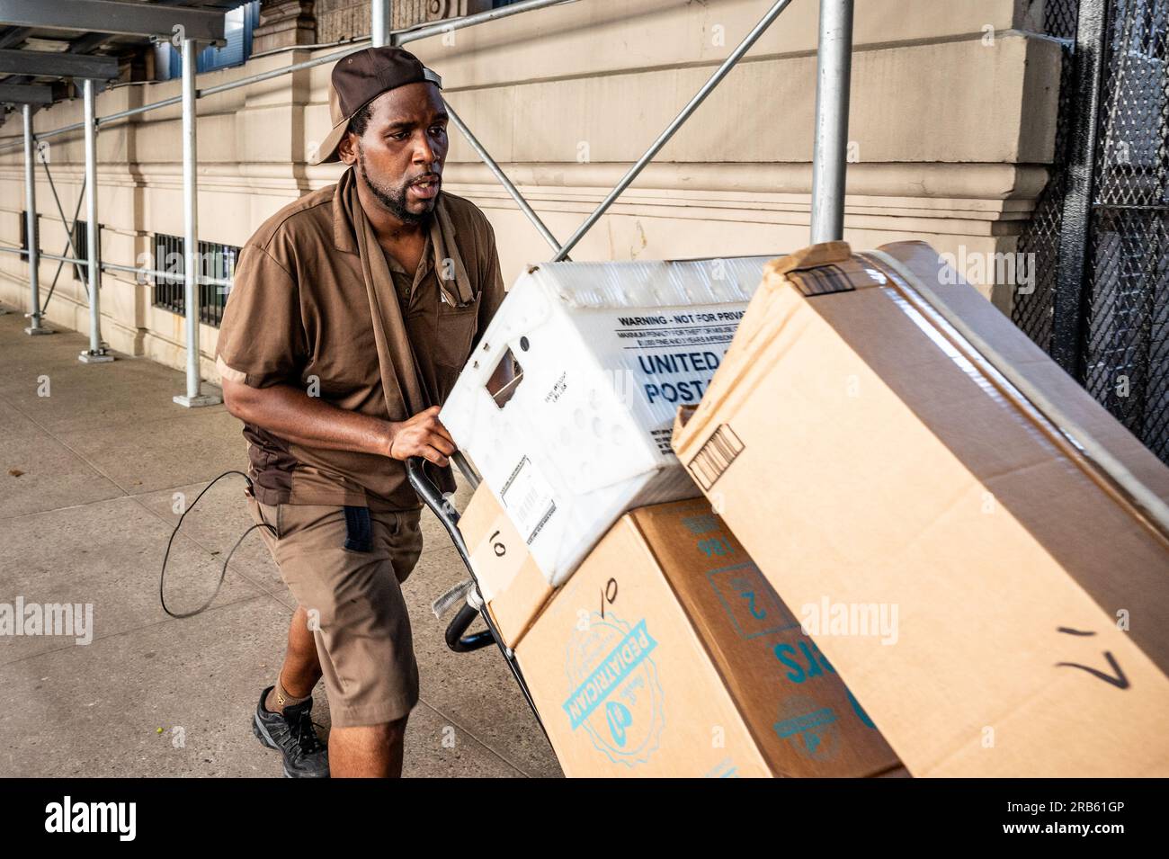 A United Parcel Service (UPS) driver delivering packages on the Upper ...