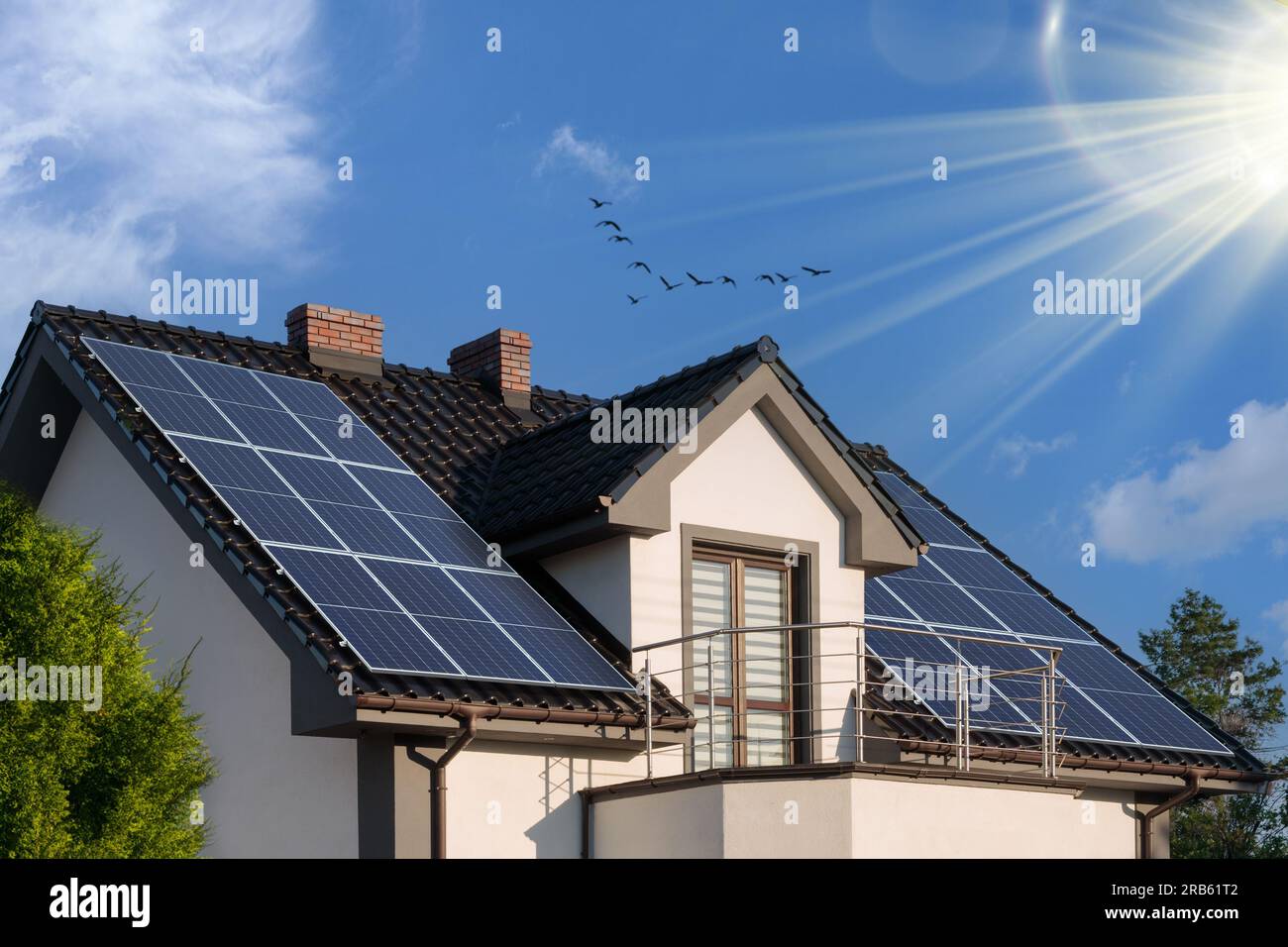 Photovoltaic panels on the roof. Modern house and solar energy. Sun ...