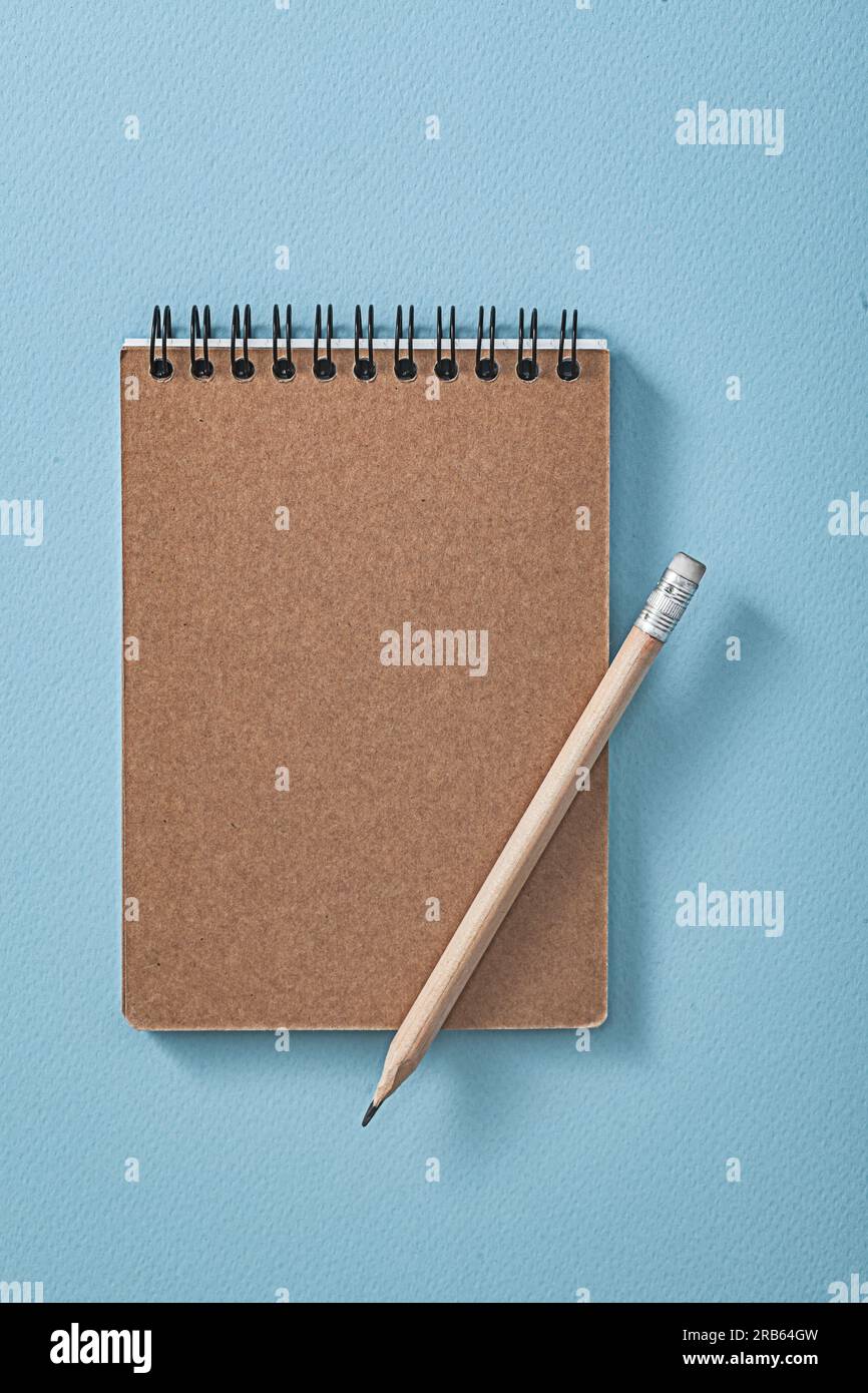 Brown Classic Notepad With Wooden Pencil On Blue Background Stock Photo ...