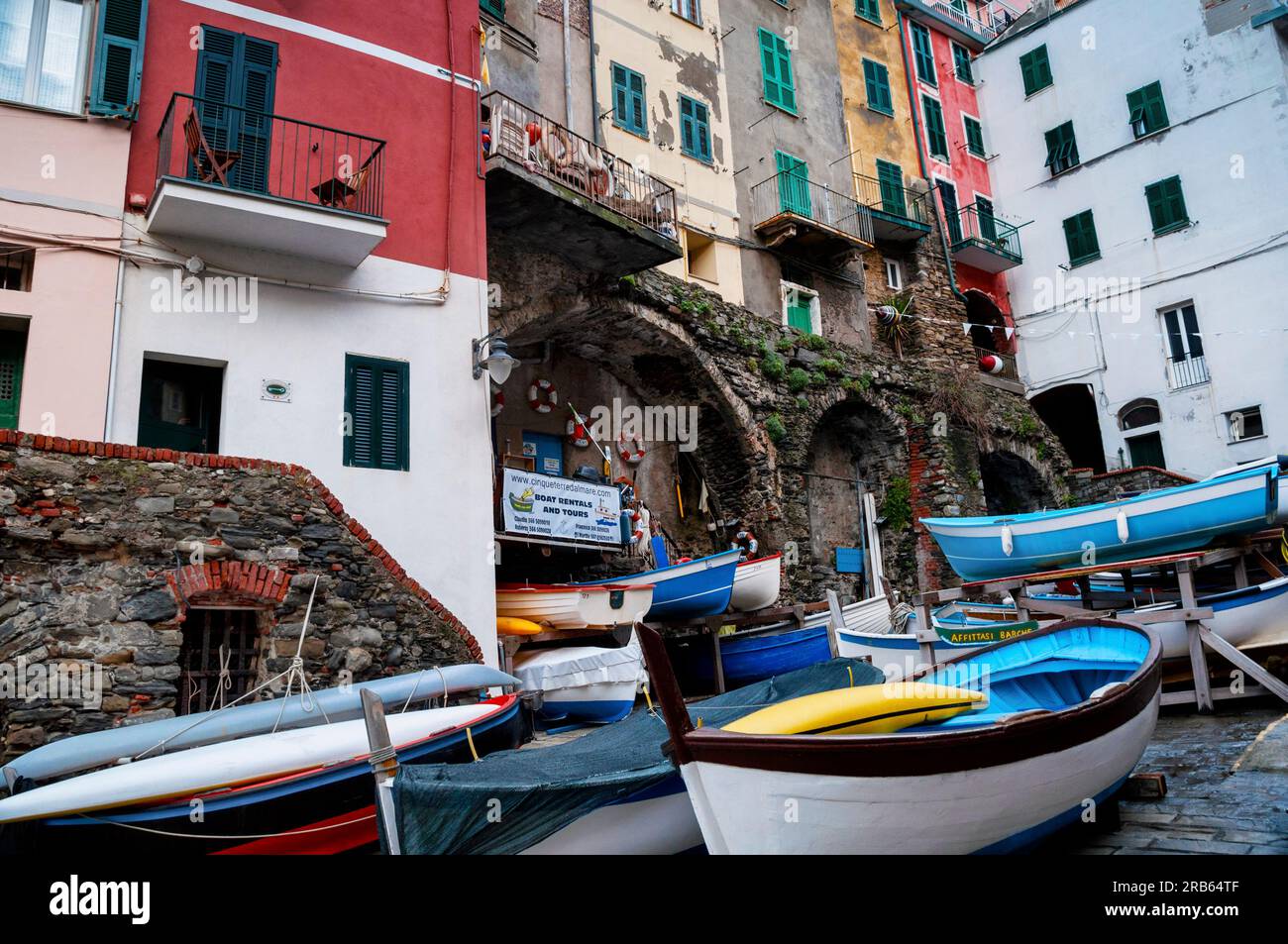 Small boats and stone arches in Riomaggiore, a fishing and grape ...