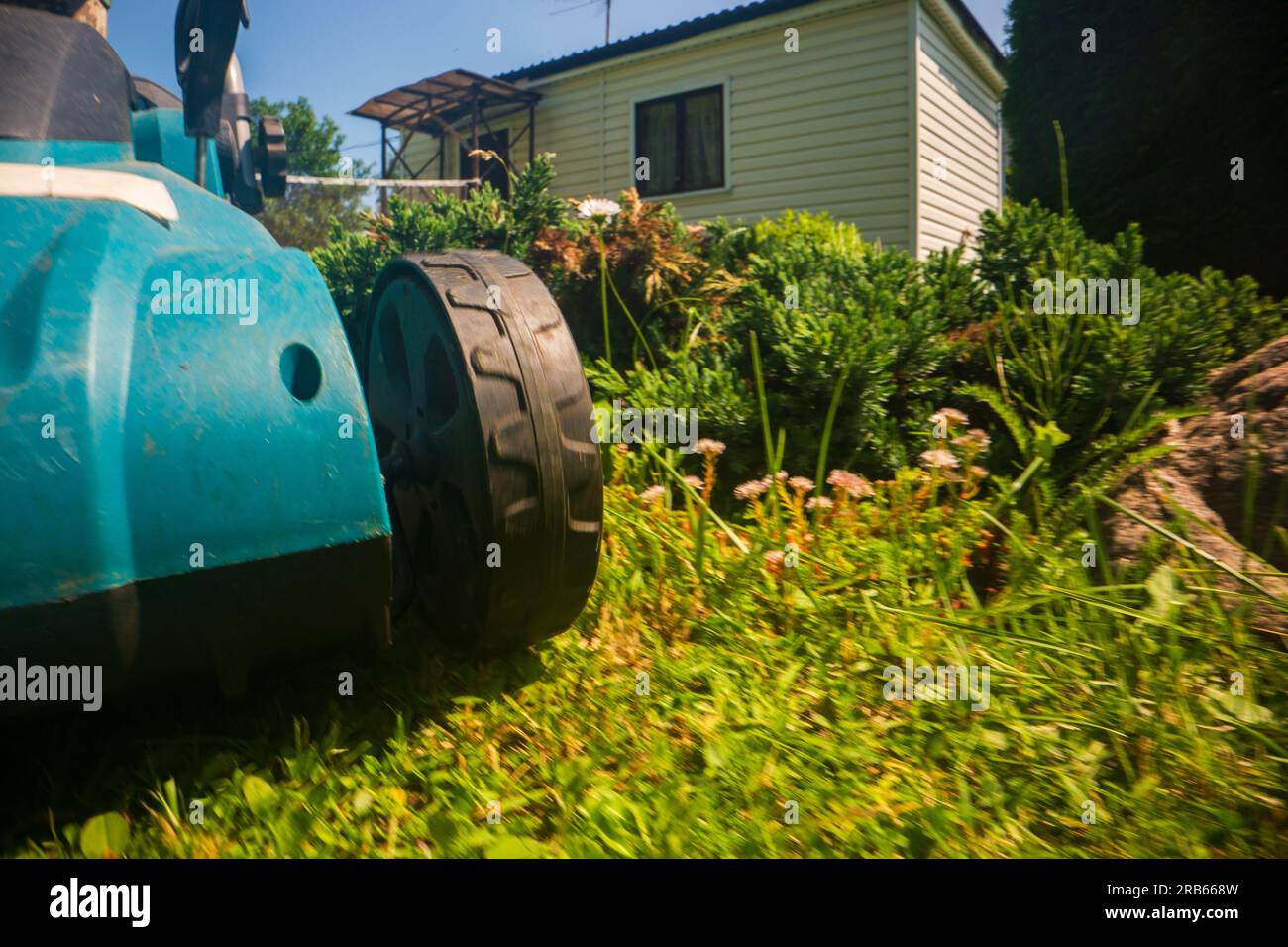 Lawn mover on green grass in modern garden or backyard. Machine for ...