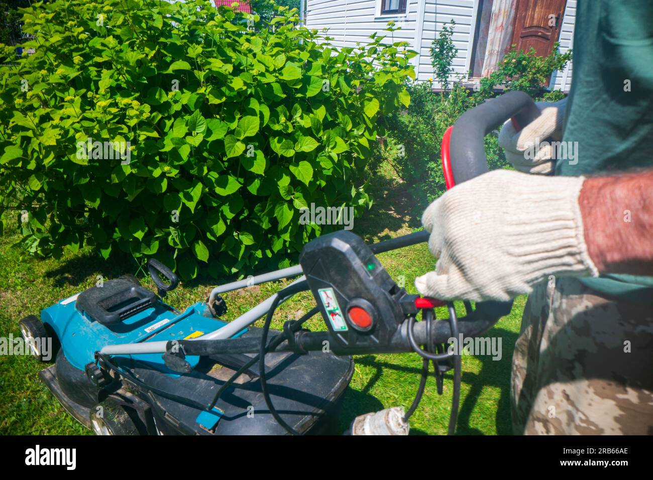 Lawn mover on green grass in modern garden or backyard. Machine for ...