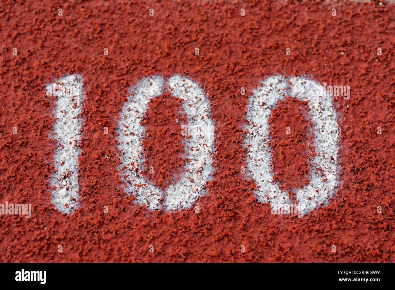 Close up of new red running track with 100 text Stock Photo - Alamy
