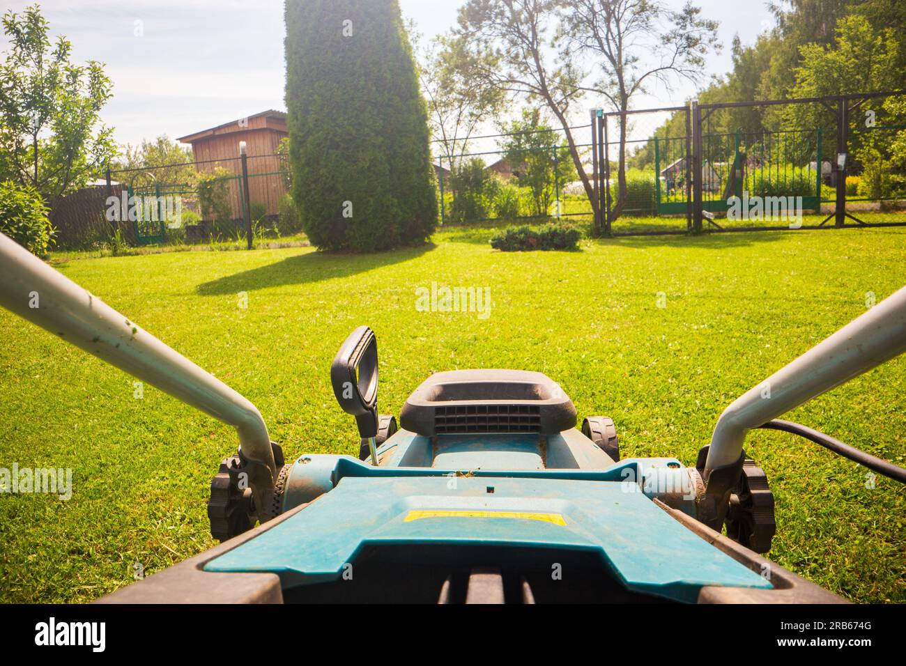 Lawn mover on green grass in modern garden or backyard. Machine for ...