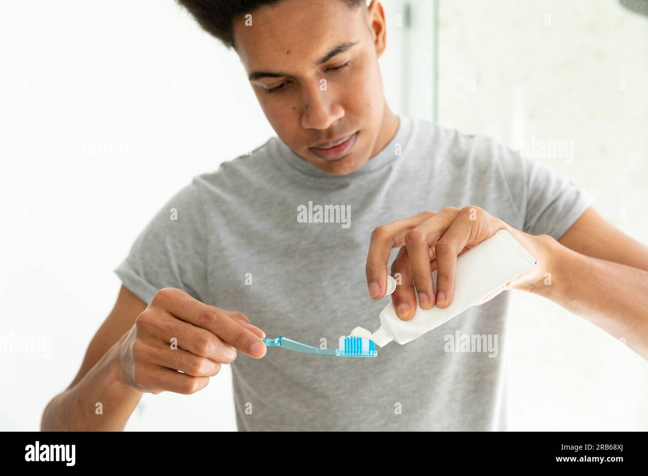 Man putting toothpaste on toothbrush hi-res stock photography and ...