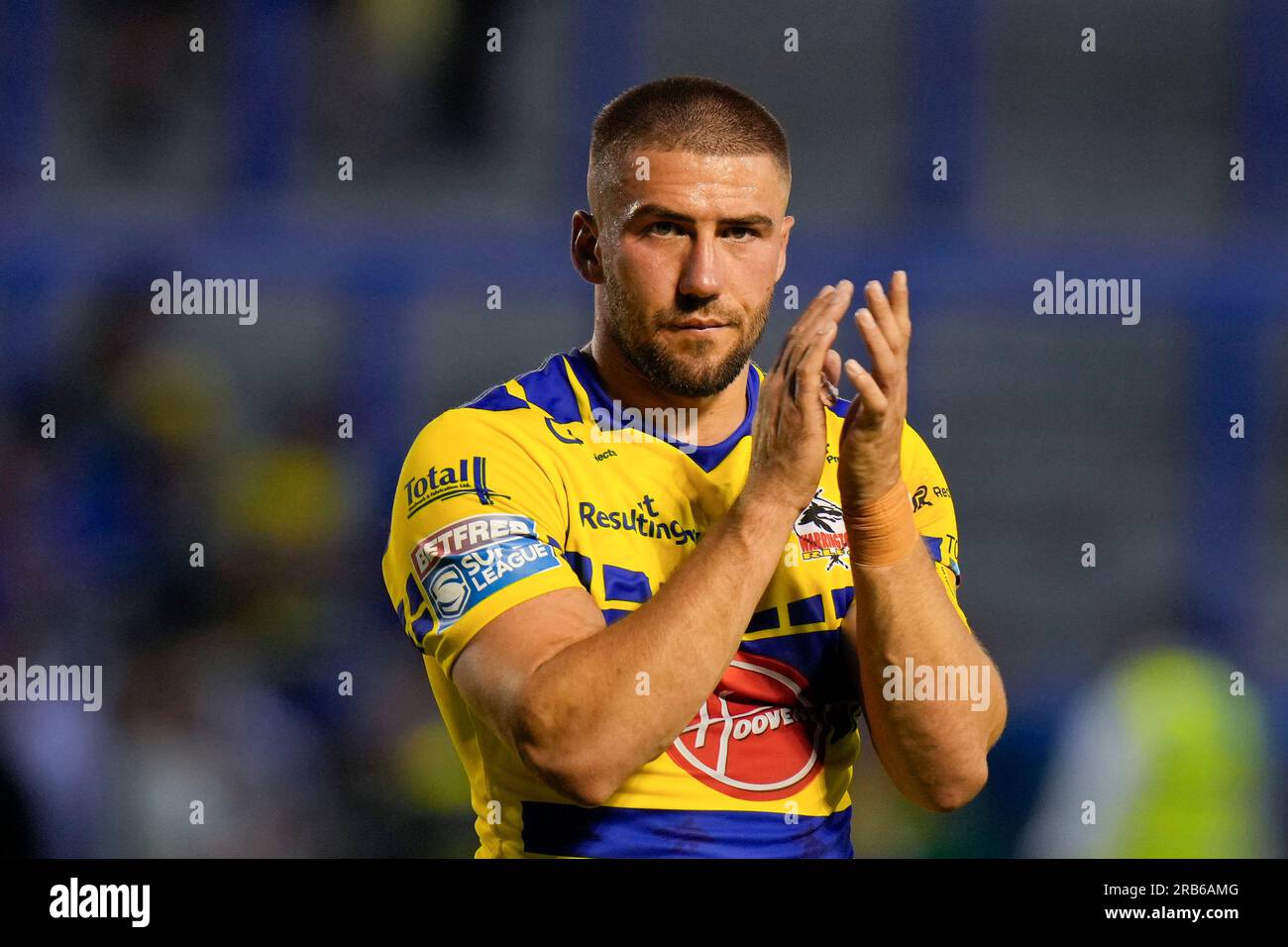 Greg Minikin #21 of Warrington Wolves salutes the fans after the ...