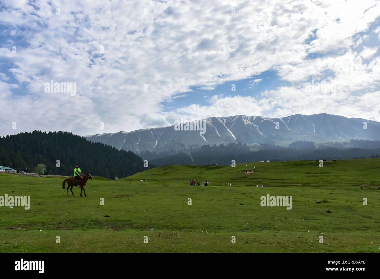 Gulmarg, India. 07th July, 2023. A man rides his horse at the Gulmarg ...