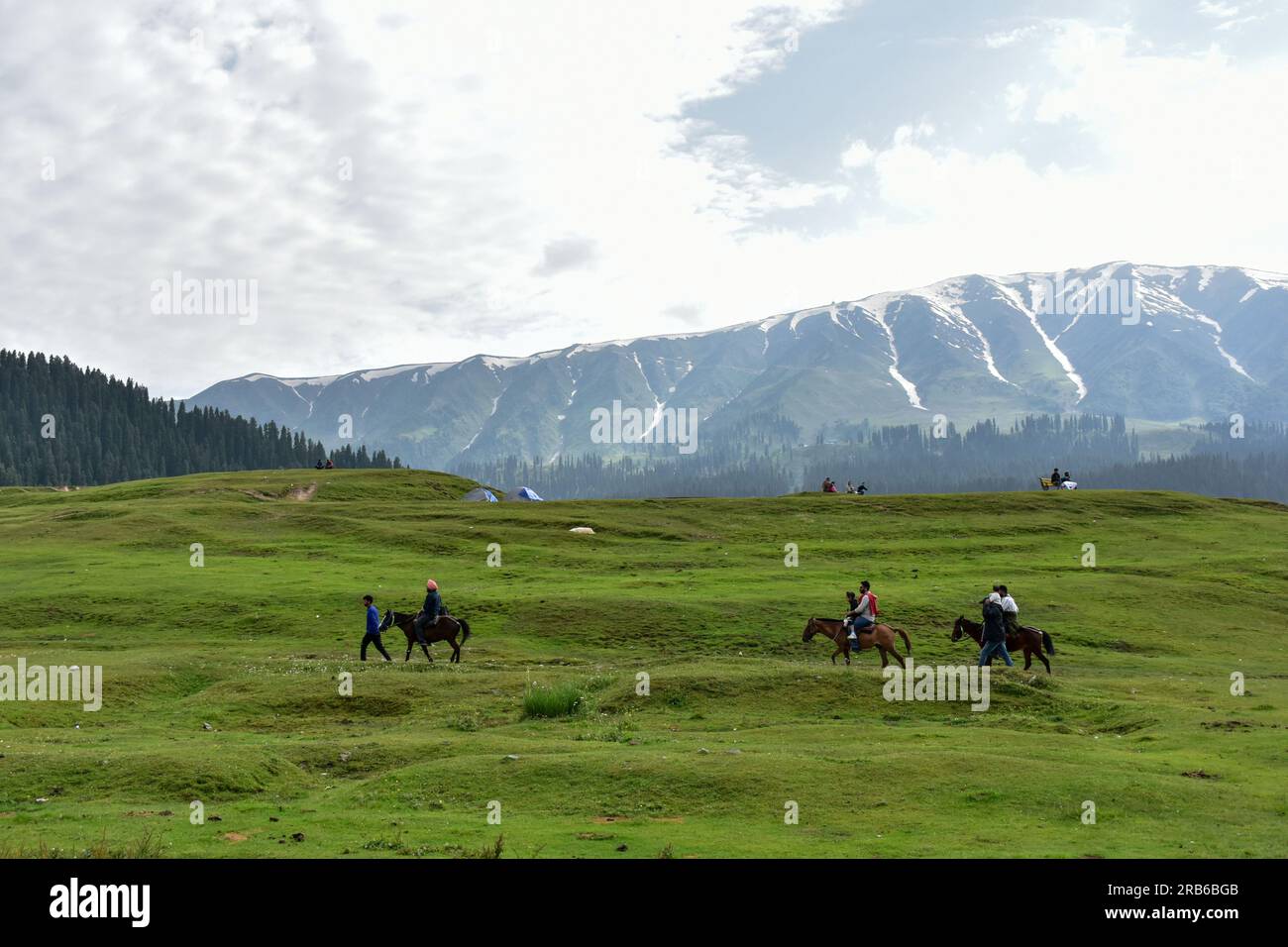 Gulmarg, India. 07th July, 2023. Indian tourists enjoy horse ride at ...
