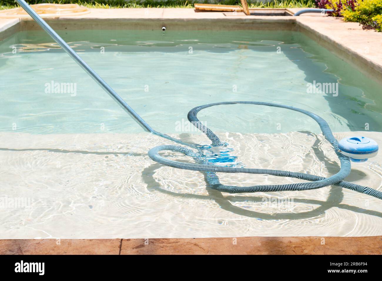 Pool cleaning with vacuum cleaner, during a sunny day. Chucum style ...