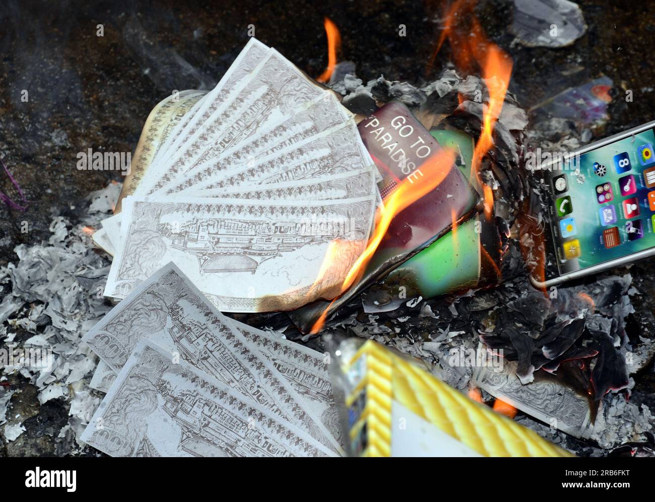 Offerings or joss papers or ghost papers being burned for a Vietnamese ...