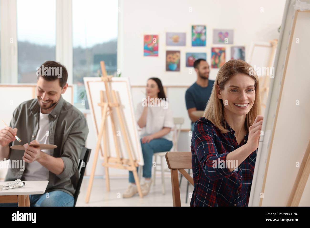 Group of students attending painting class in studio. Creative hobby ...