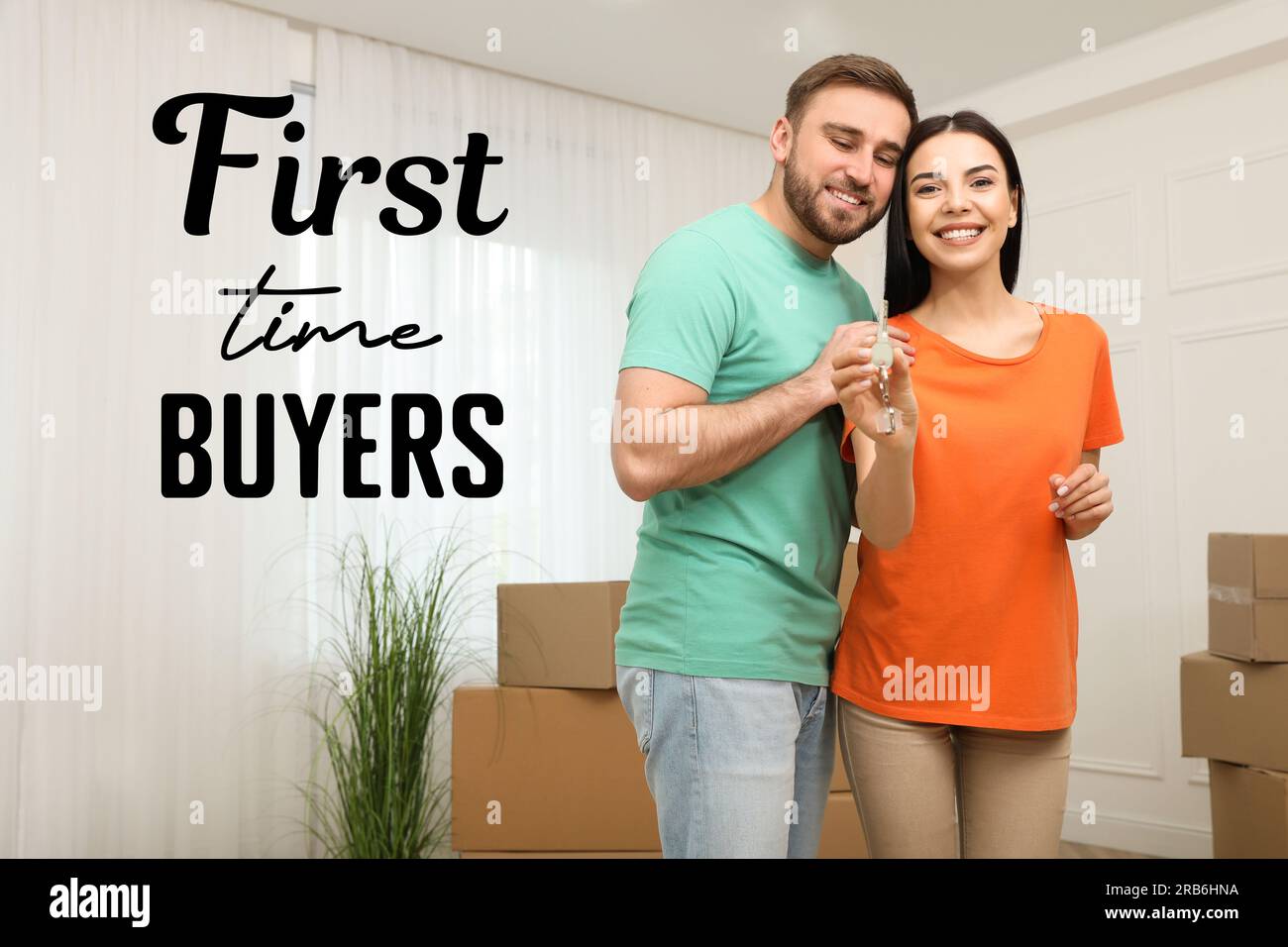 First-time buyer. Happy young couple with key in their new house Stock ...