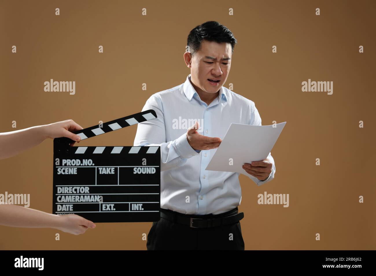 Emotional asian actor performing role while second assistant camera ...